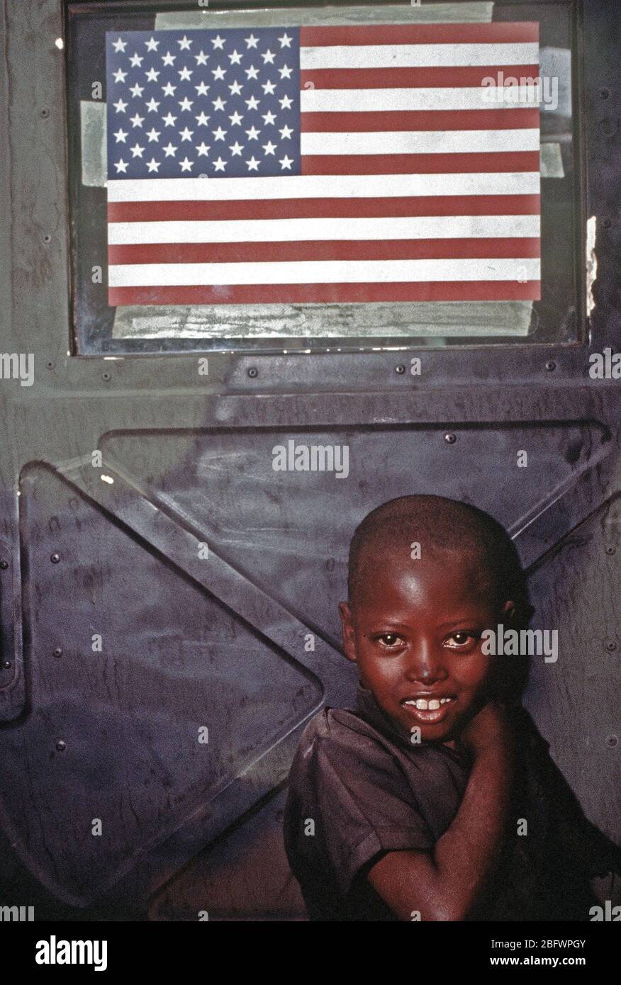 1994 - Close up view of a little boy as he poses under a replica of the ...