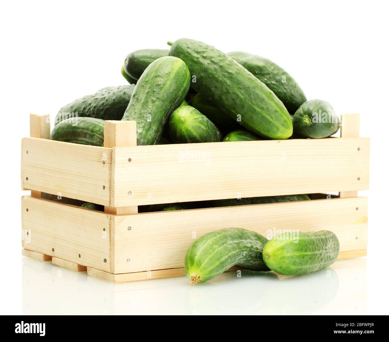 fresh cucumbers in wooden box isolated on white Stock Photo - Alamy