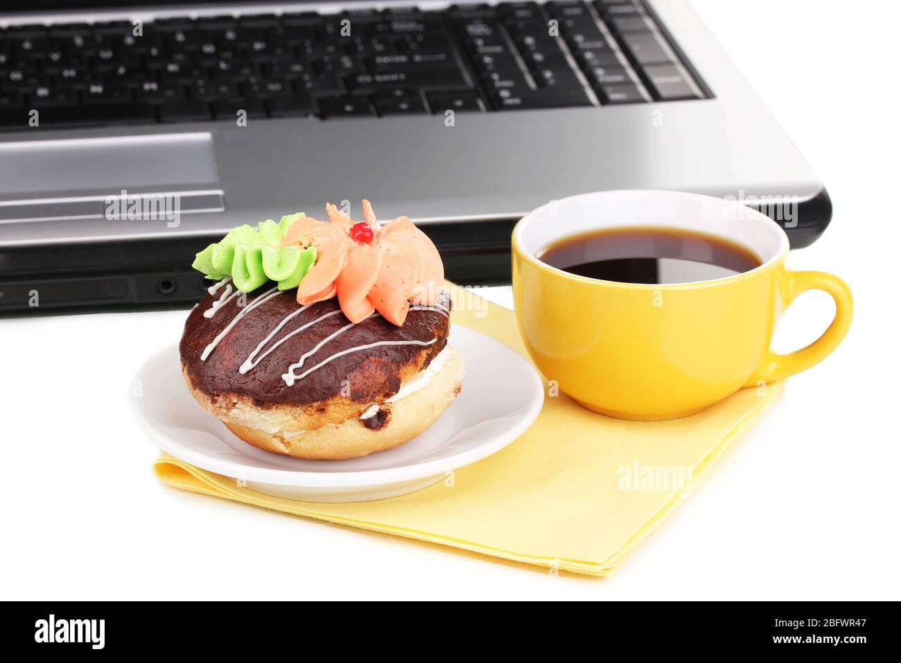 Eating at work place near laptop Stock Photo - Alamy