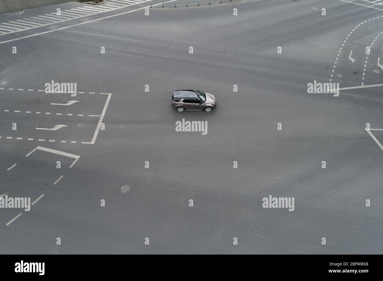 Aerial view of single car driving on intersection Stock Photo - Alamy