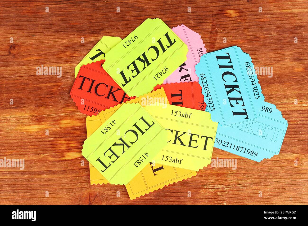 Colorful tickets on wooden background close-up Stock Photo - Alamy