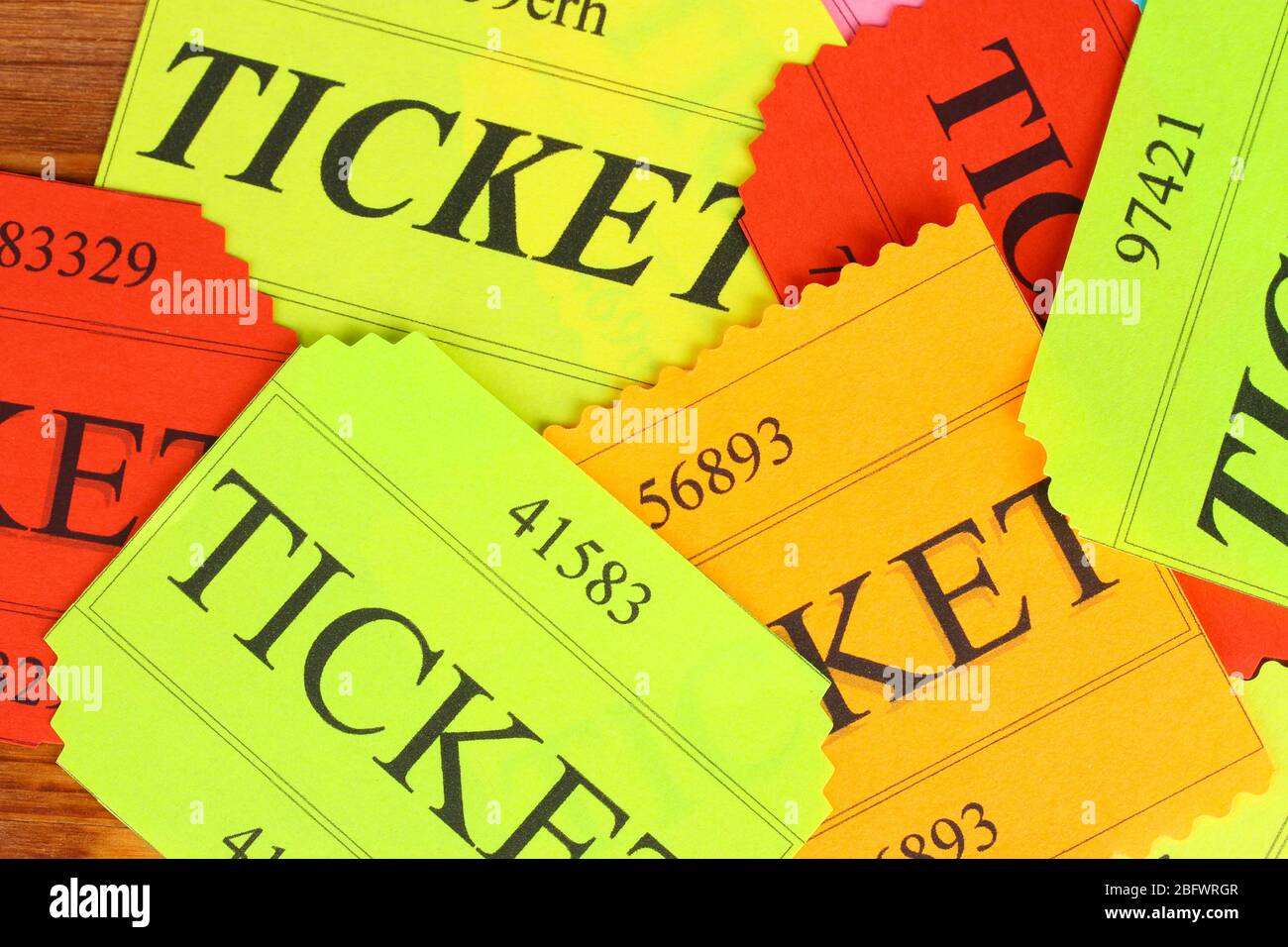 Colorful tickets on wooden background close-up Stock Photo - Alamy