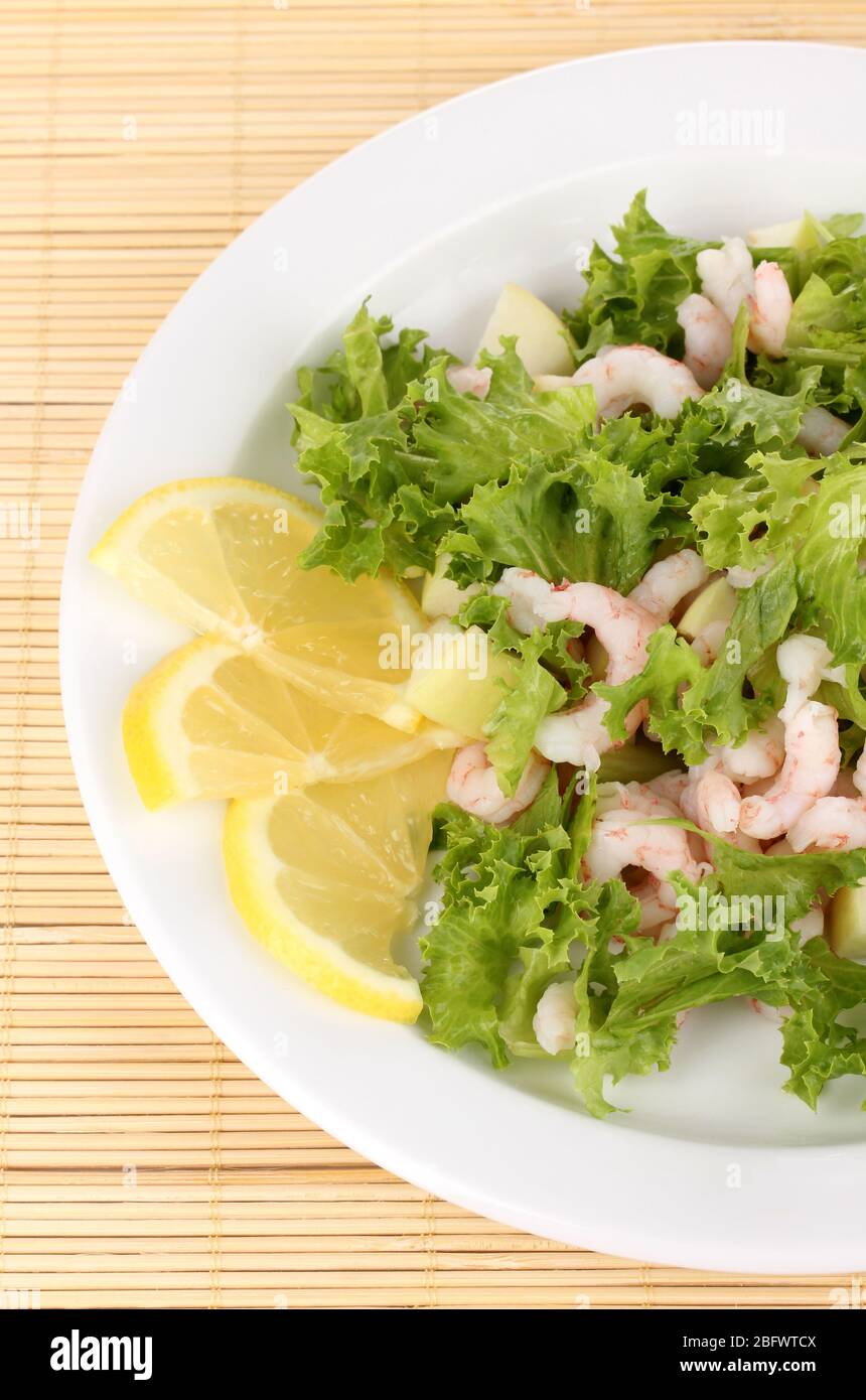 Delicious marinated shrimp in plate on bamboo mat Stock Photo - Alamy