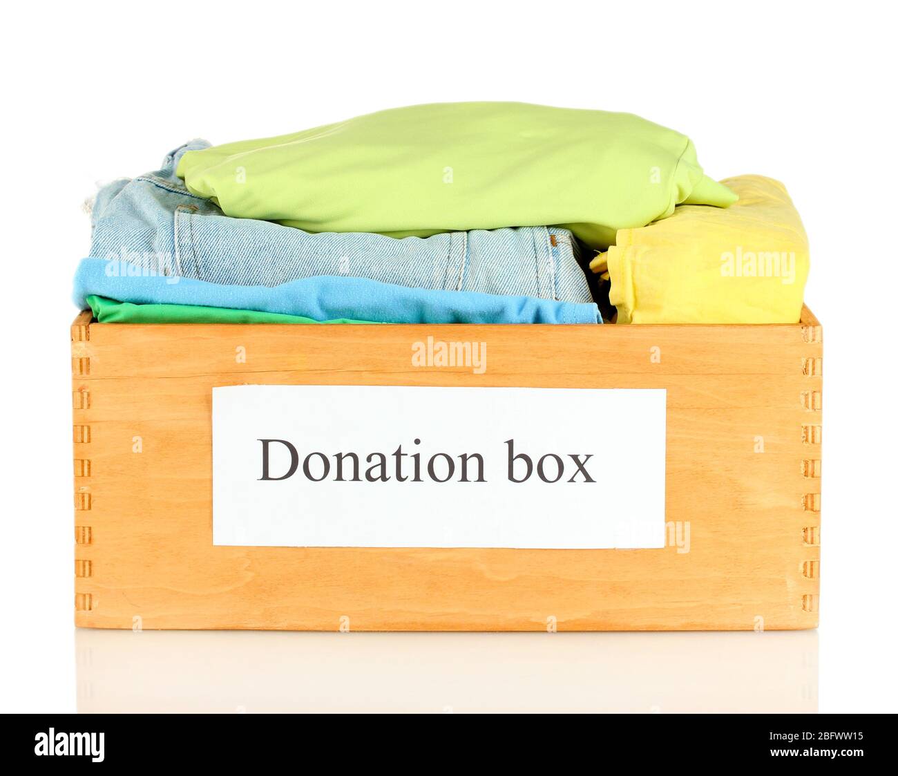 Donation box with clothing isolated on white Stock Photo - Alamy