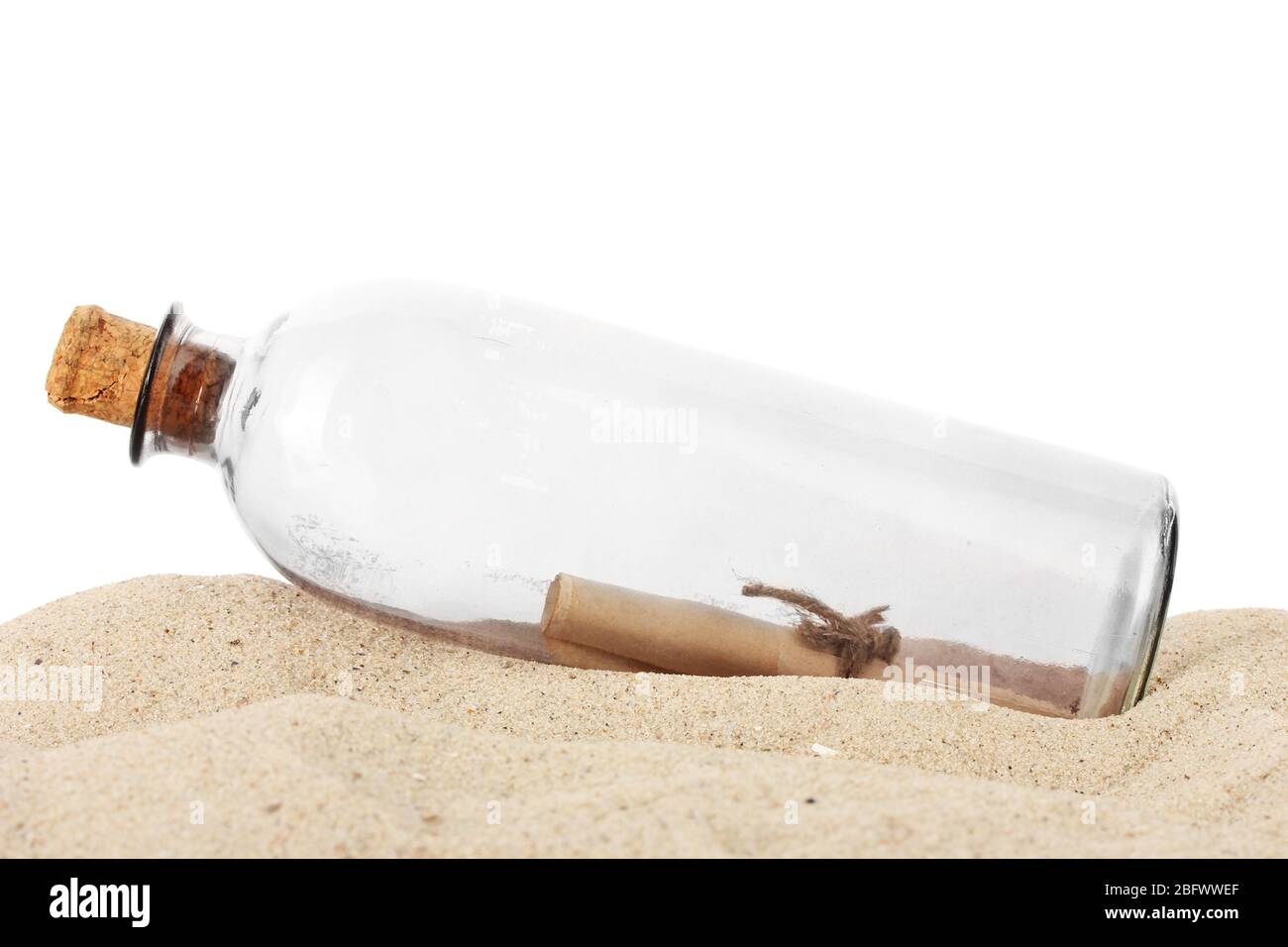 Glass bottle with note inside on sand isolated on white Stock Photo - Alamy