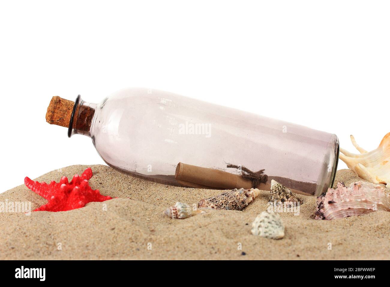 Glass bottle with note inside on sand isolated on white Stock Photo - Alamy