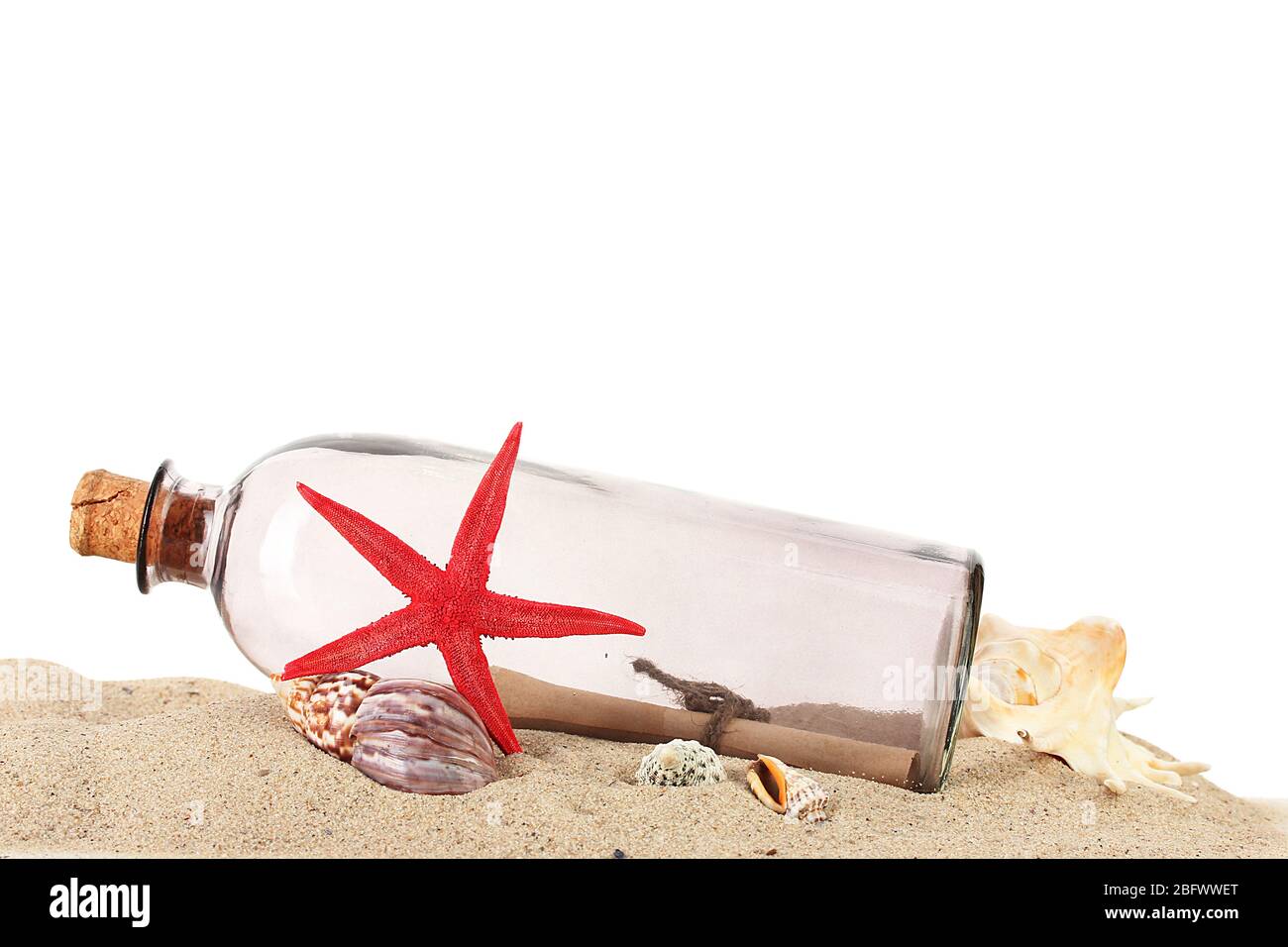 Glass bottle with note inside on sand isolated on white Stock Photo - Alamy