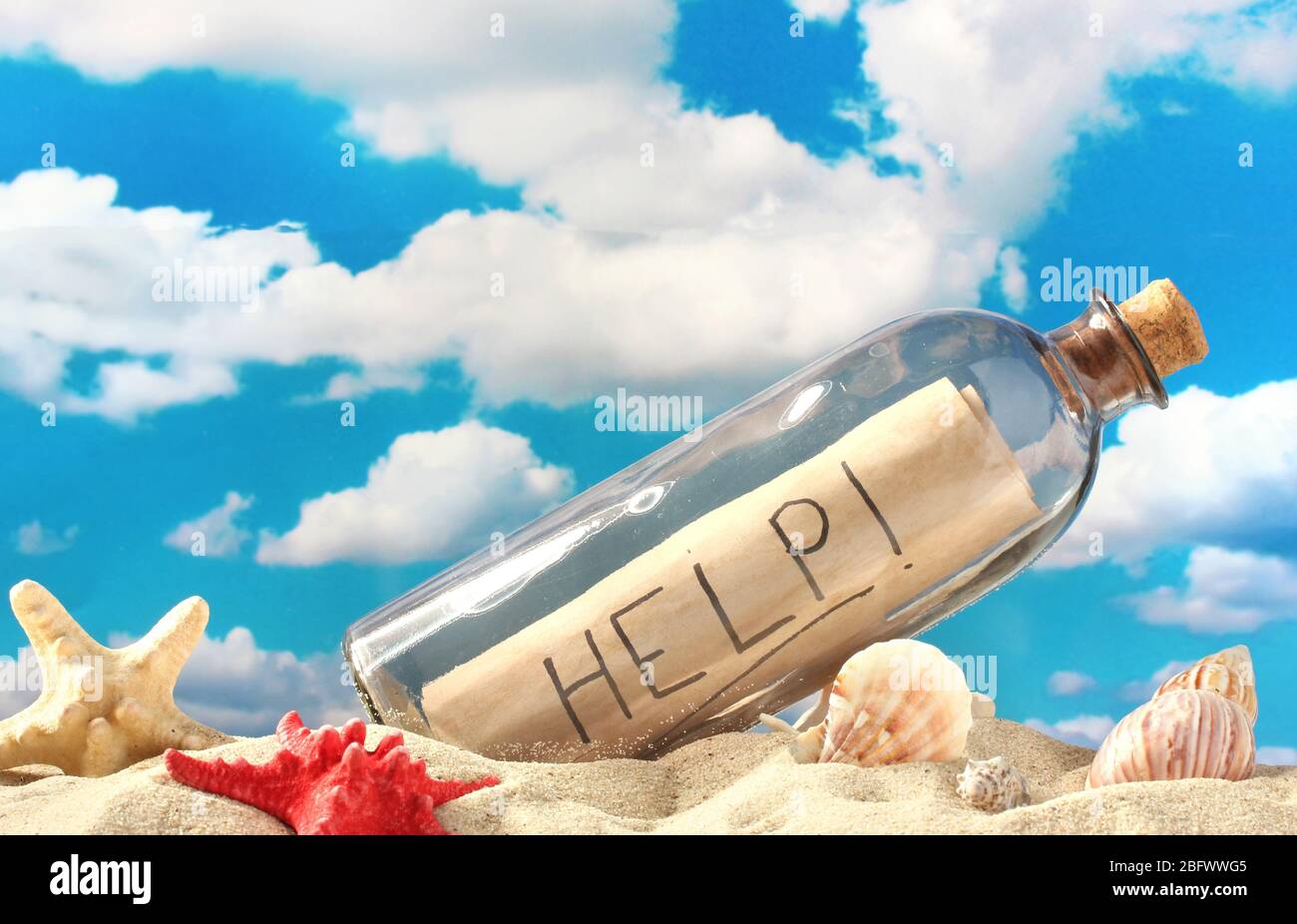 Glass bottle with note inside on sand, on blue sky background Stock ...