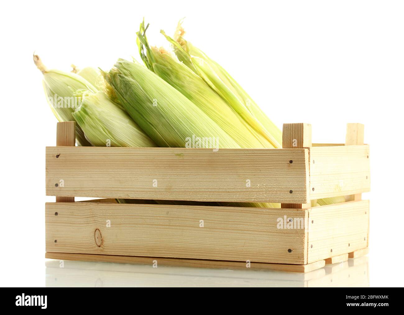 fresh corn in wooden box, isolated on white Stock Photo - Alamy