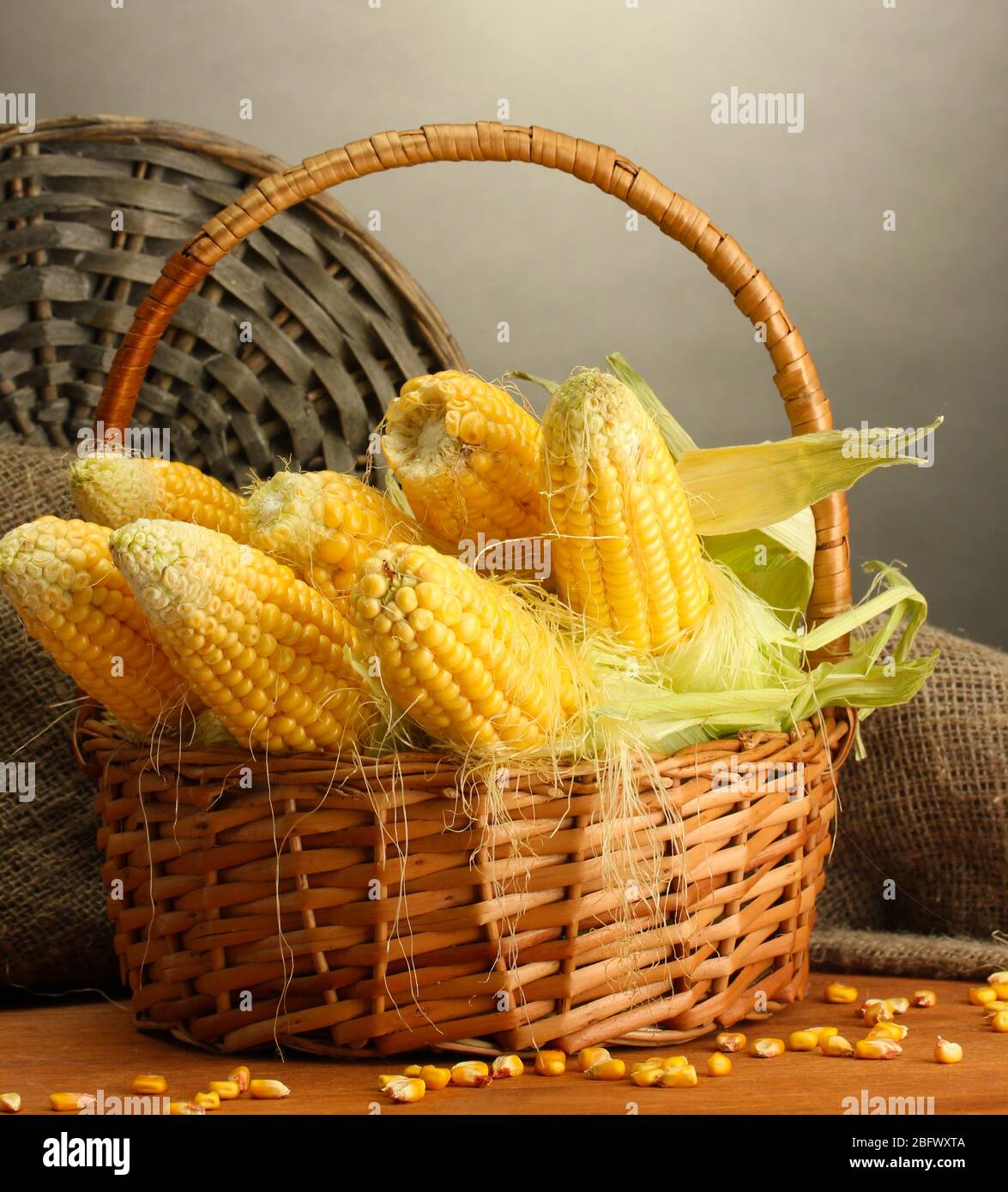 fresh corn in basket, on wooden table, on grey background Stock Photo ...