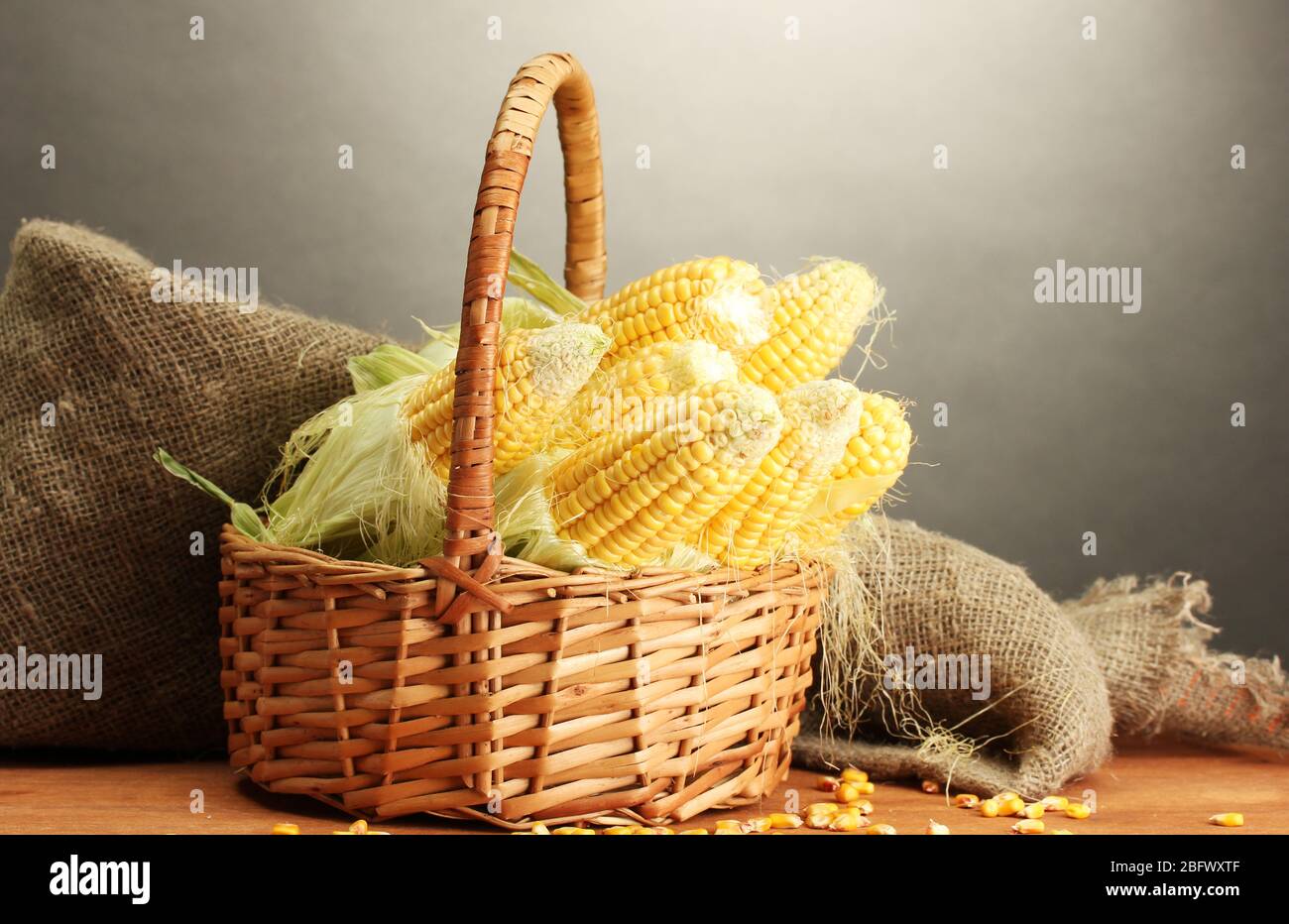 fresh corn in basket, on wooden table, on grey background Stock Photo ...