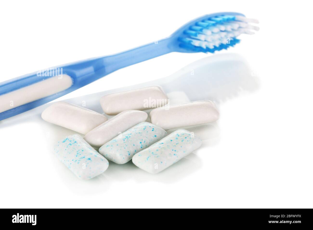 Chewing gum and toothbrush close-up isolated on white Stock Photo - Alamy