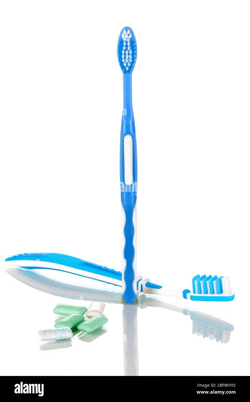 Toothbrushes and chewing gum isolated on white Stock Photo - Alamy