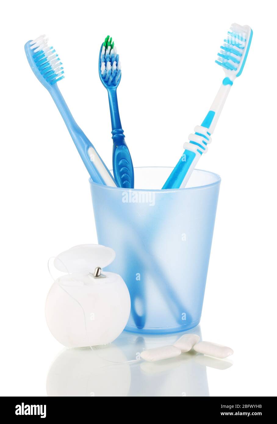 Toothbrushes, chewing gum and dental floss isolated on white Stock ...
