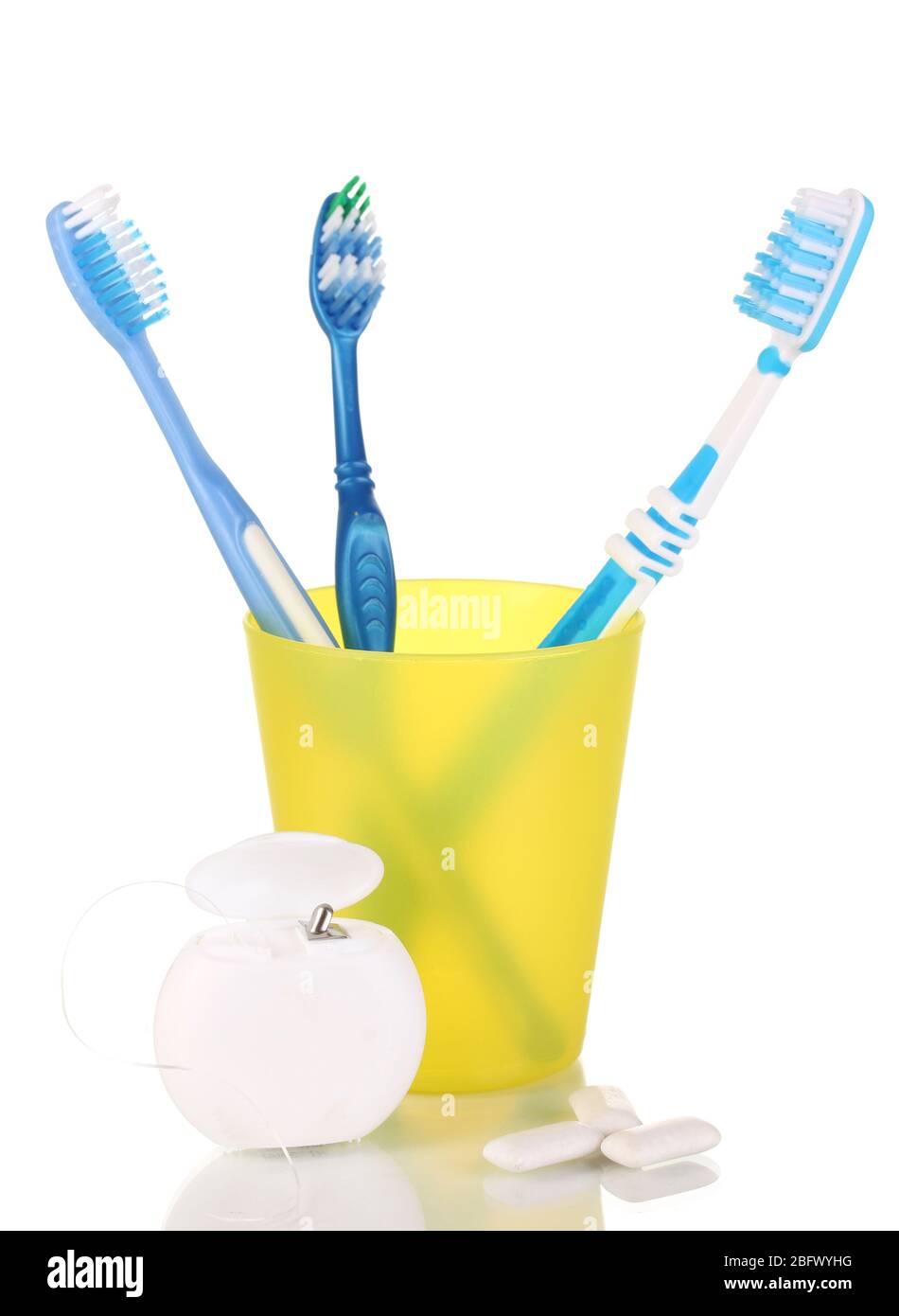 Toothbrushes, chewing gum and dental floss isolated on white Stock ...