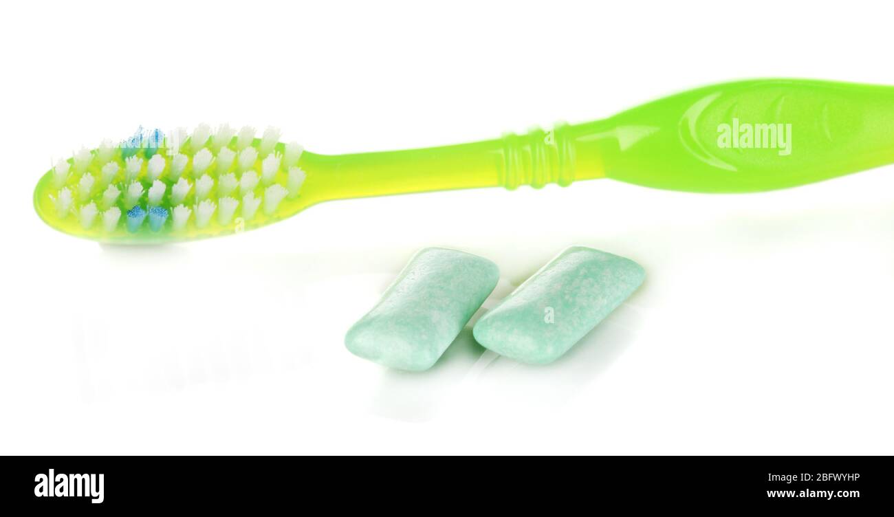 Toothbrush and chewing gum isolated on white Stock Photo - Alamy