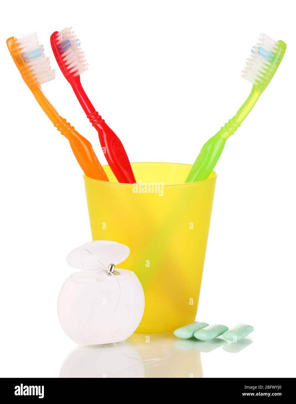 Toothbrushes, chewing gum and dental floss isolated on white Stock ...
