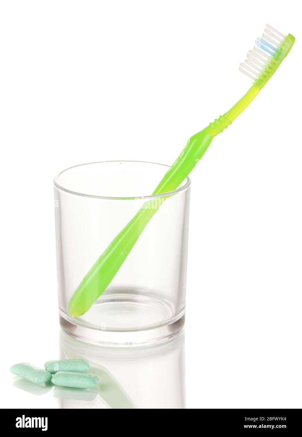 Toothbrush in glass and chewing gum isolated on white Stock Photo - Alamy