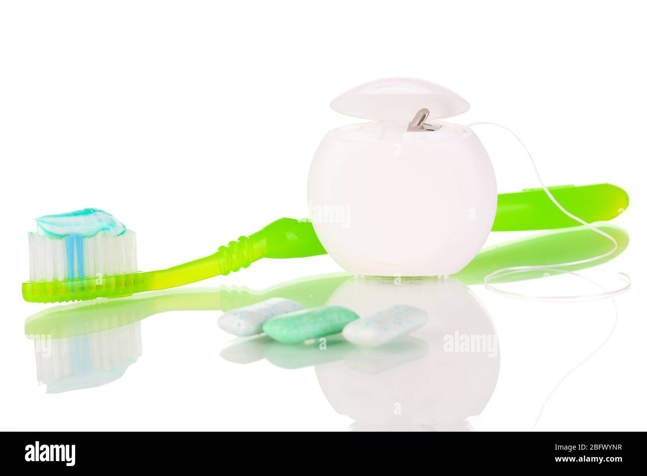 Toothbrush, chewing gum and dental floss isolated on white Stock Photo ...