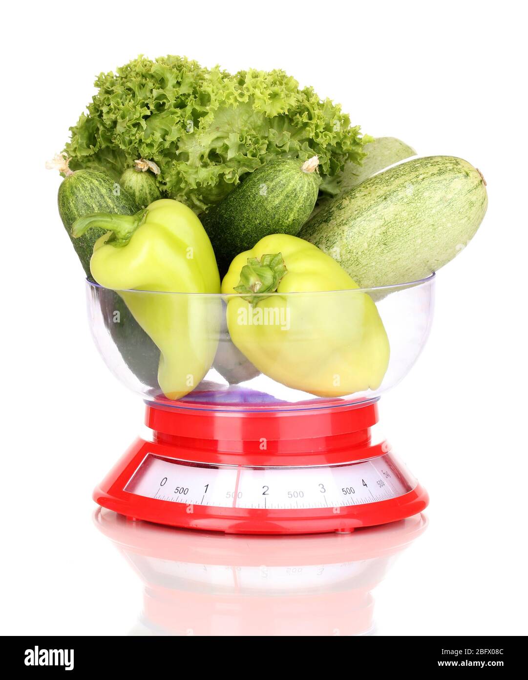 fresh green vegetables in scales isolated on white Stock Photo - Alamy