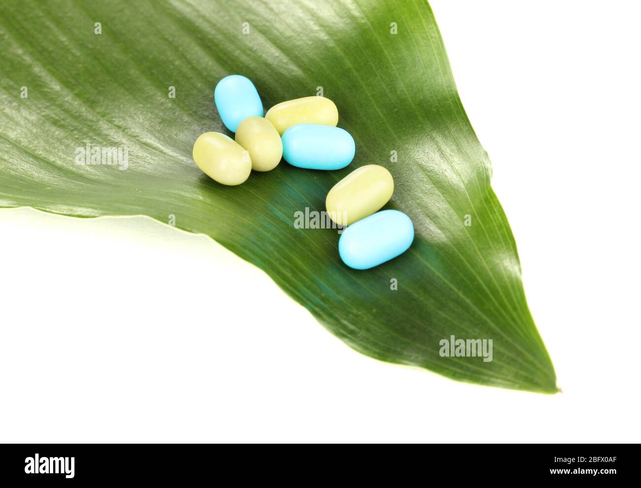 tablets on green leaf isolated on white Stock Photo - Alamy