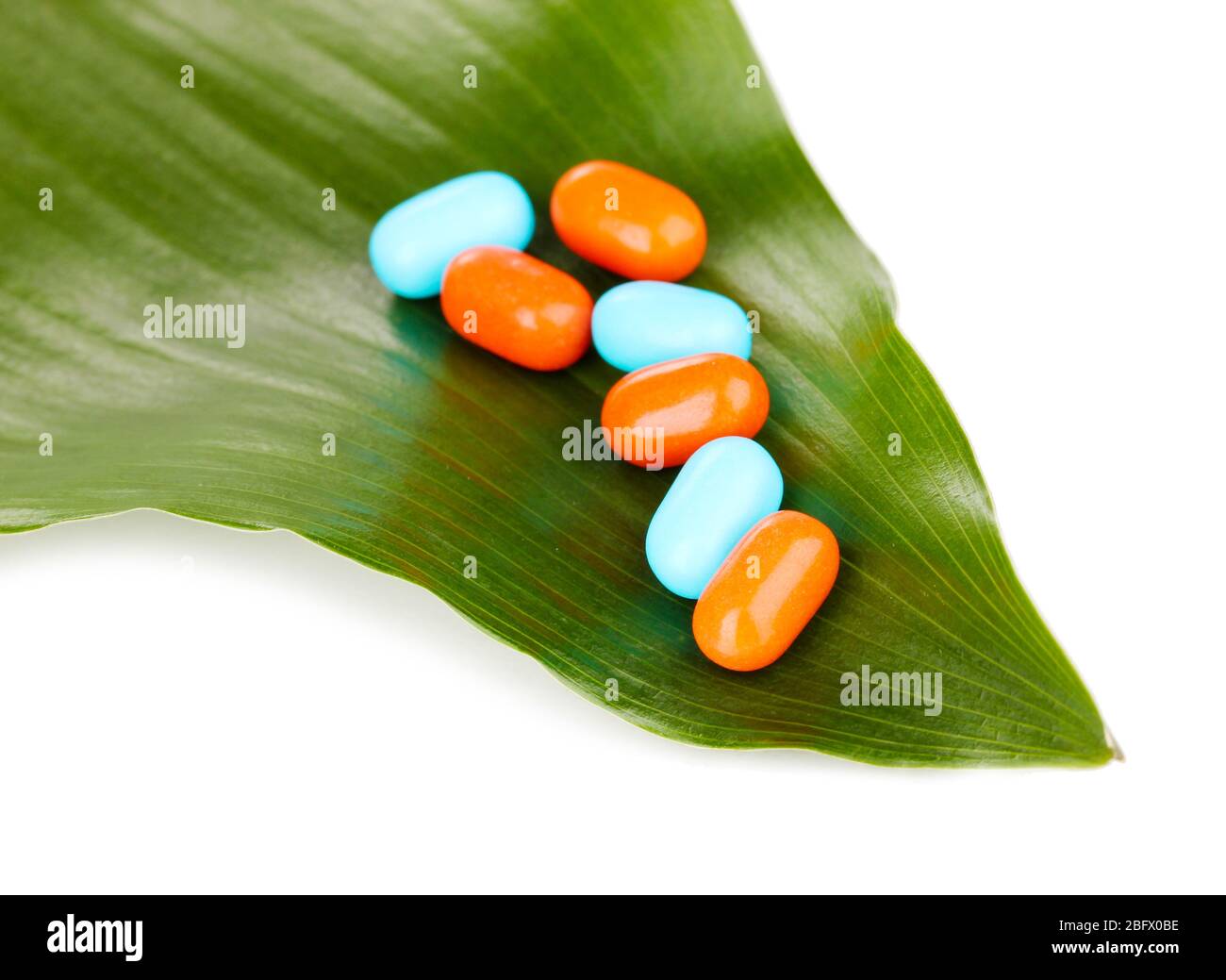 tablets on green leaf isolated on white Stock Photo - Alamy