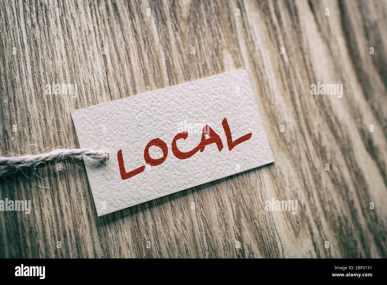 LOCAL handwritten paper gift box label on brown wood texture background ...