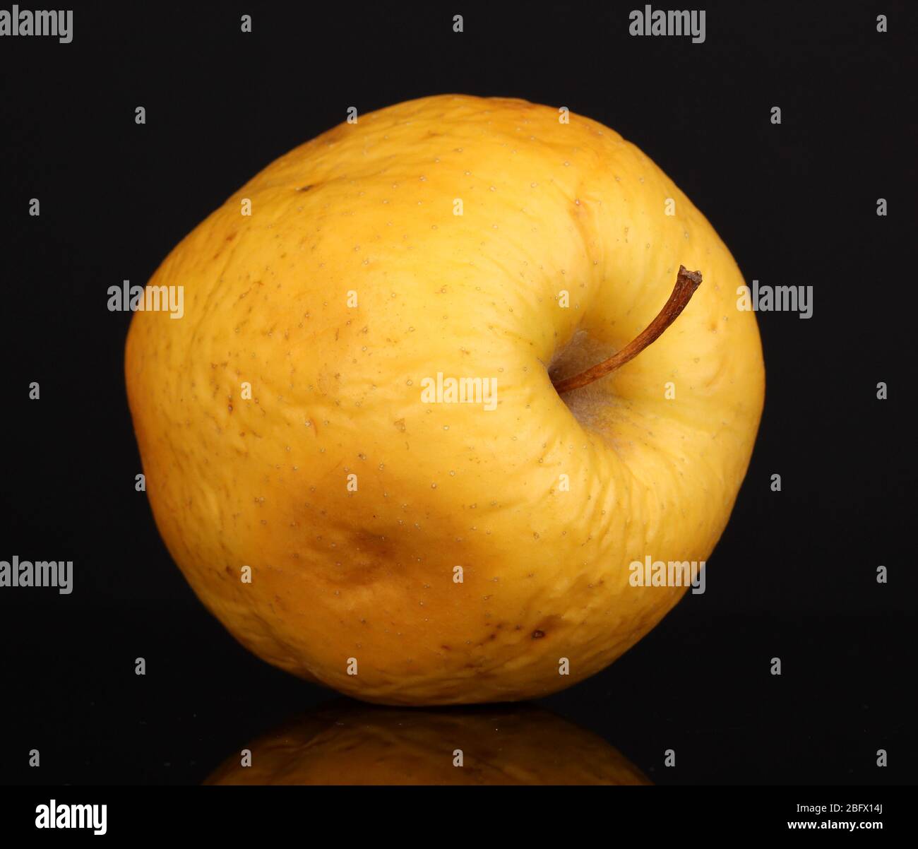 Yellow apple as problem skin concept isolated on black Stock Photo - Alamy