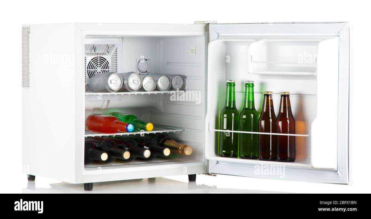 Mini fridge full of bottles of alcoholic beverages isolated on white ...