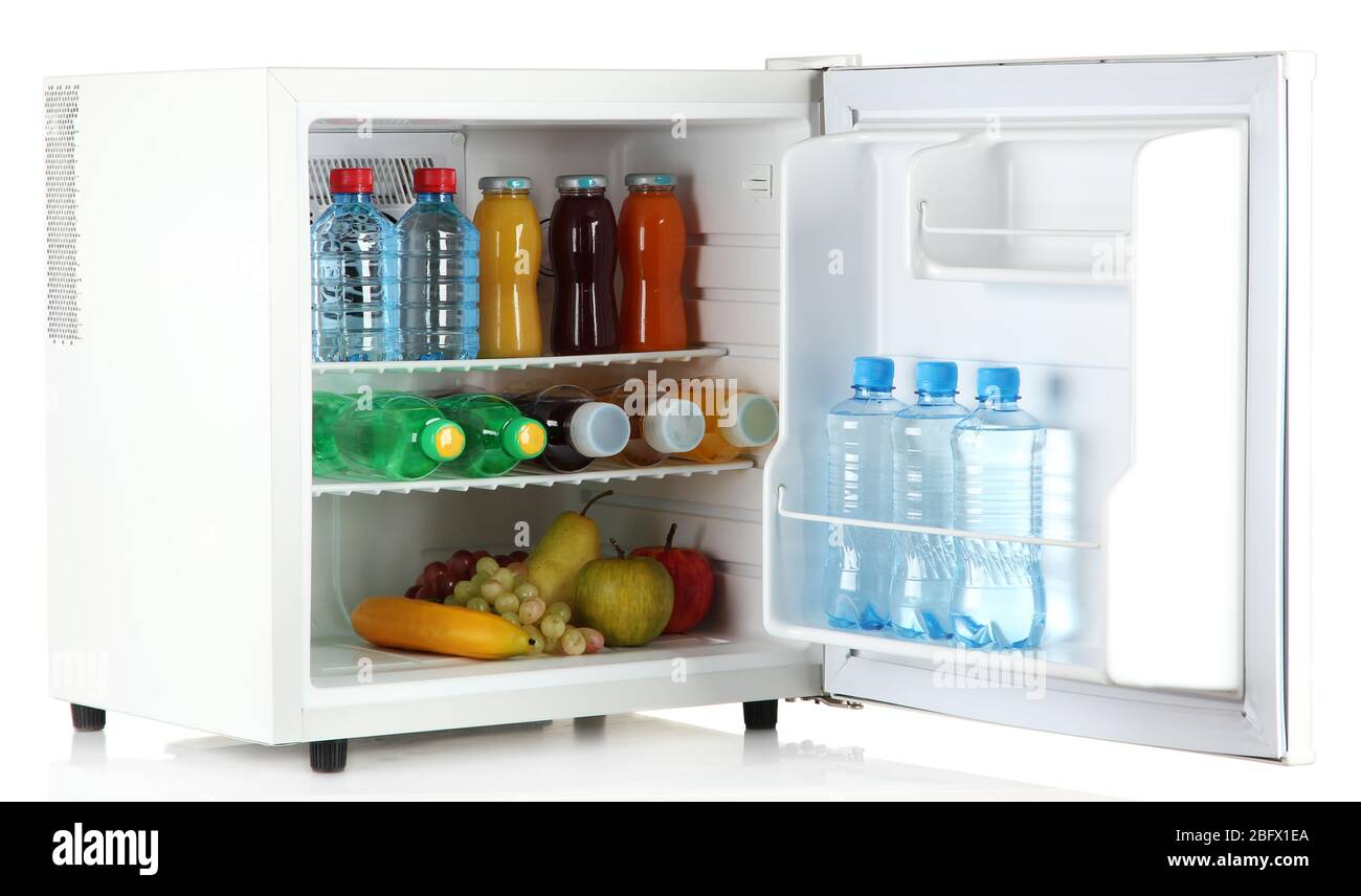 mini fridge full of bottles of juice, soda and fruit isolated on white ...