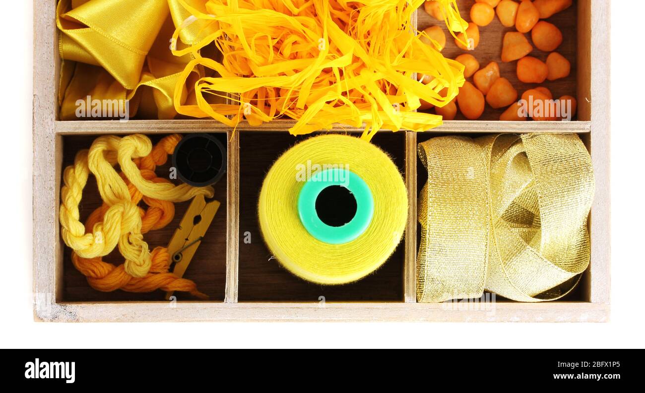 Yellow thread and material for handicrafts in box isolated on white ...