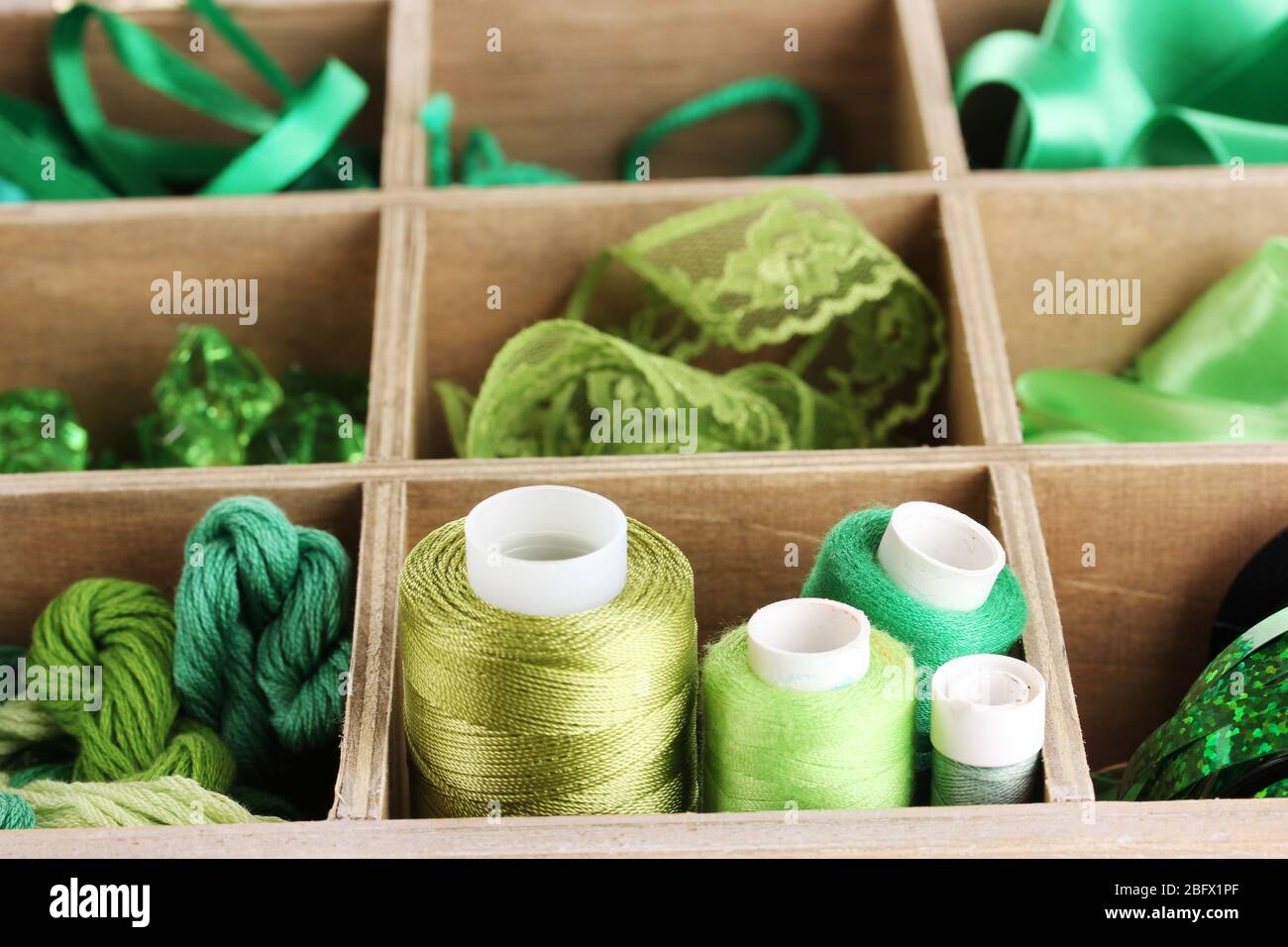 Green thread and material for handicrafts in box close-up Stock Photo ...