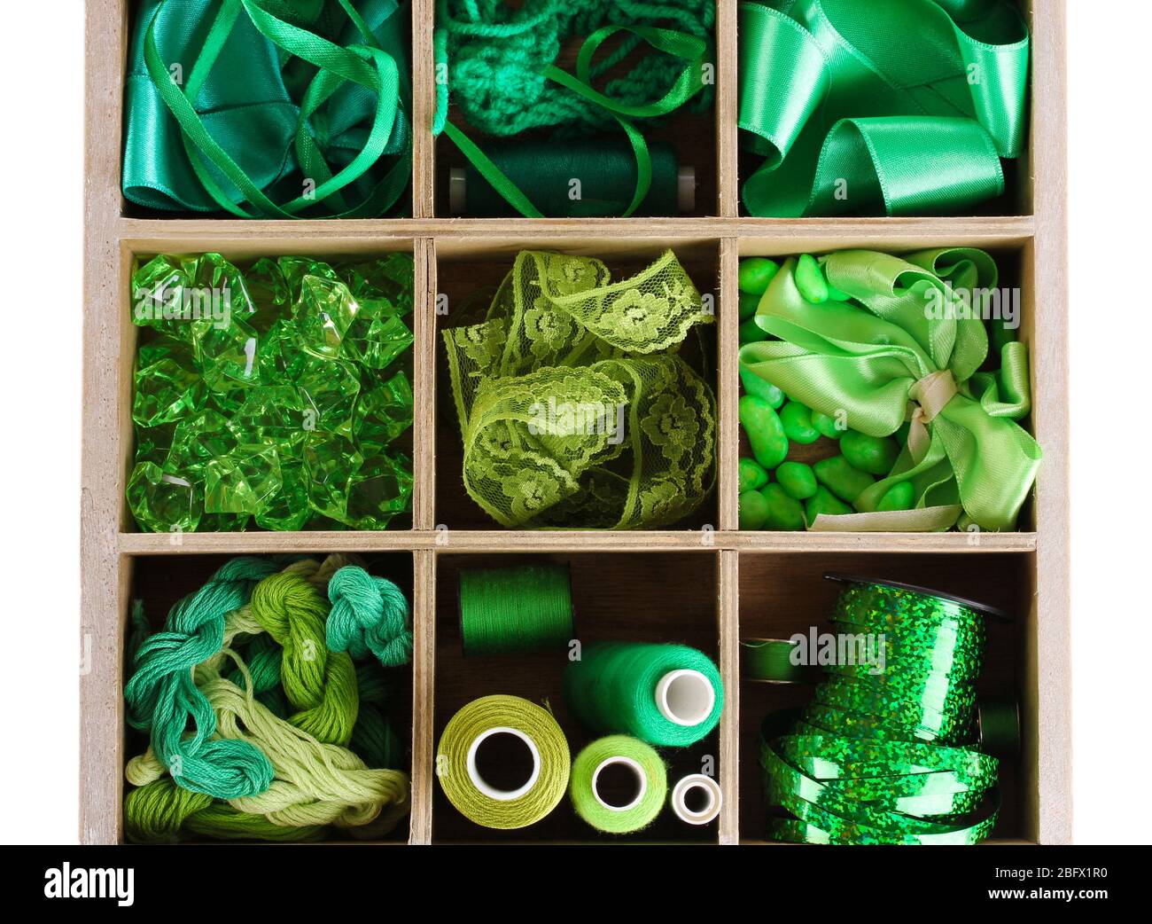 Green thread and material for handicrafts in box isolated on white ...