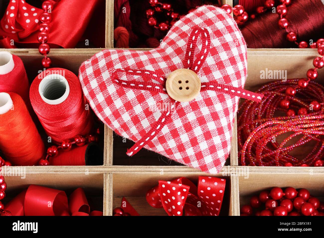 Red thread and material for handicrafts in box close-up Stock Photo - Alamy
