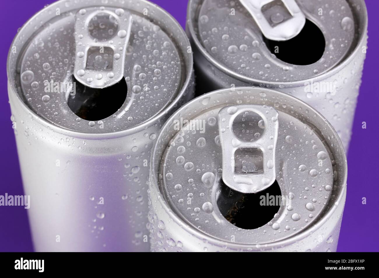 aluminum cans with water drops on purple background Stock Photo - Alamy