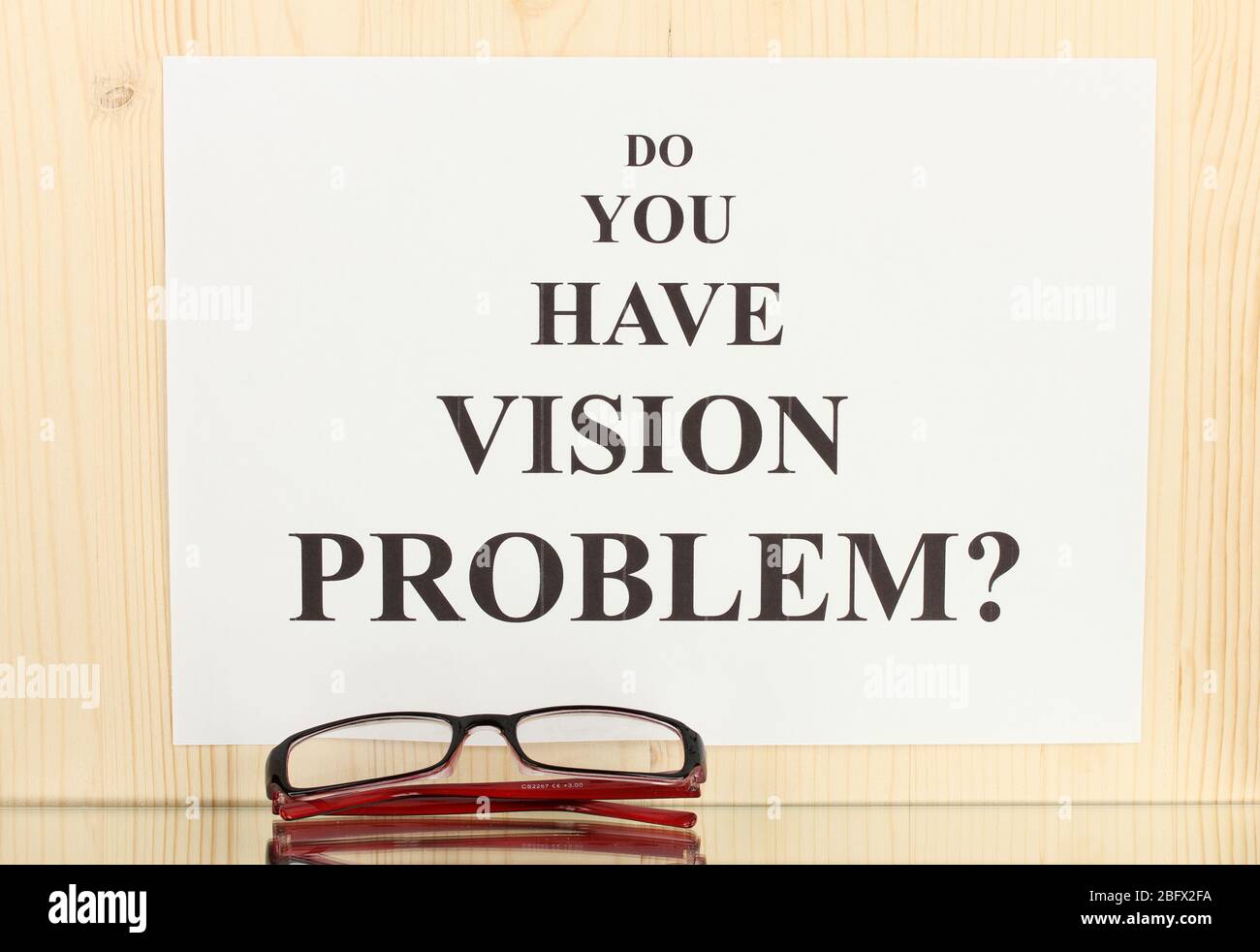 Eyesight test chart with glasses on wooden background close-up Stock ...
