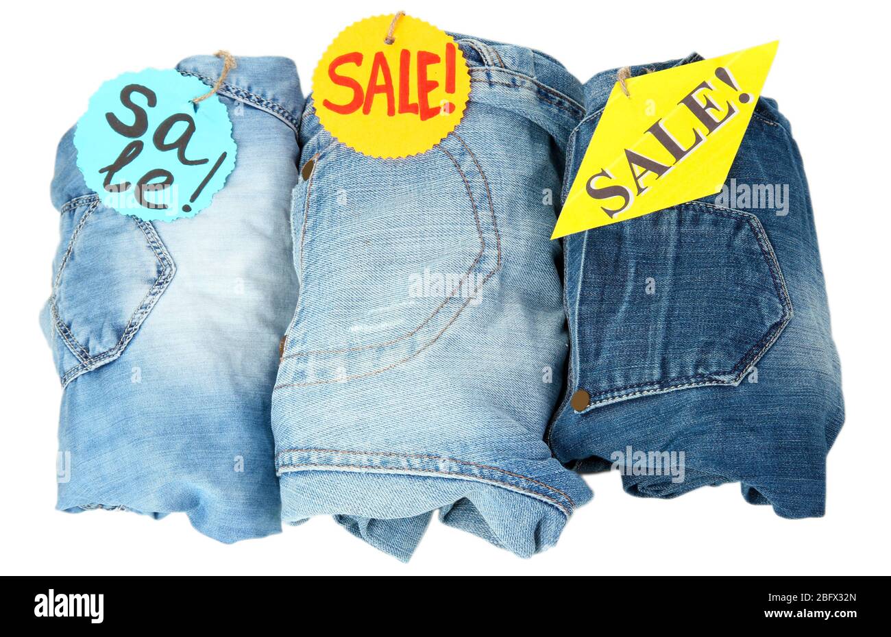 Three fashion blue jeans on sale close-up isolated on white Stock Photo ...