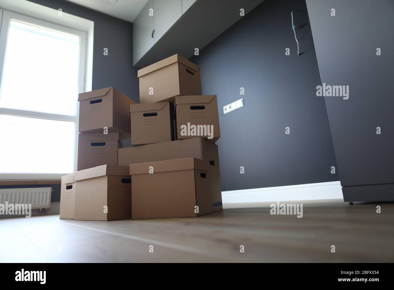 Empty office interior, boxes stand near window Stock Photo - Alamy