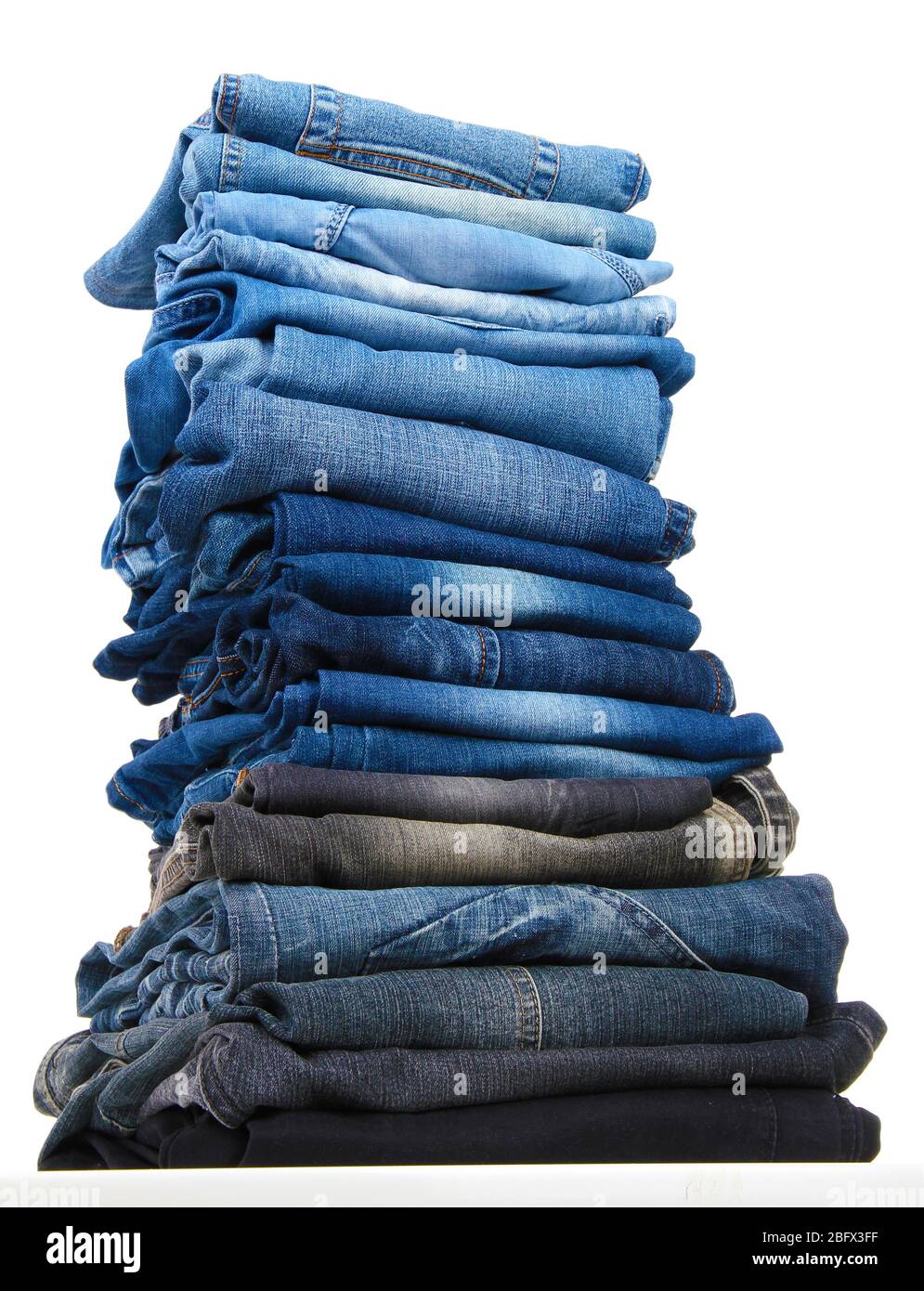 Many jeans stacked in a pile isolated on white Stock Photo - Alamy