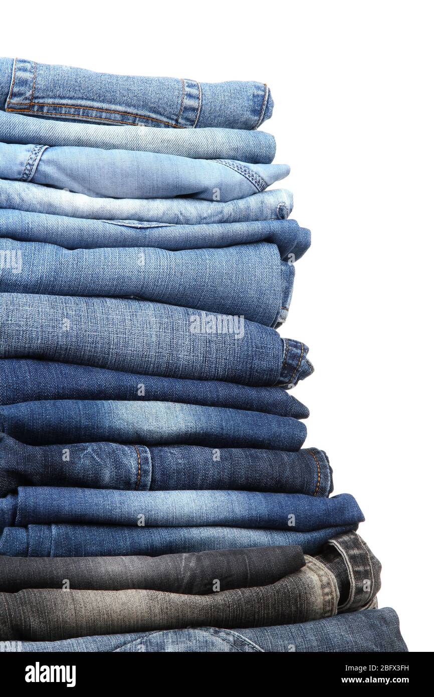Many jeans stacked in a pile isolated on white Stock Photo - Alamy