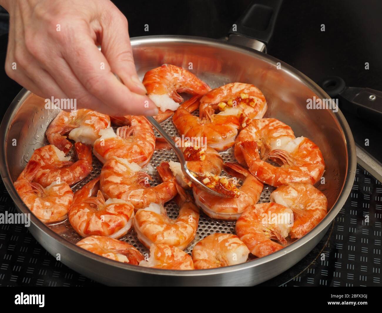 Frying organic black tiger prawns in a steel pan Stock Photo - Alamy