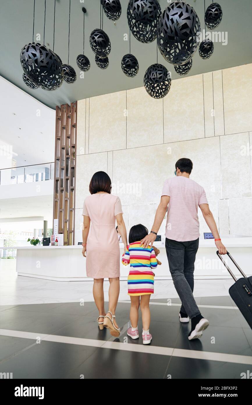 Family of three hotel reception hi-res stock photography and images - Alamy