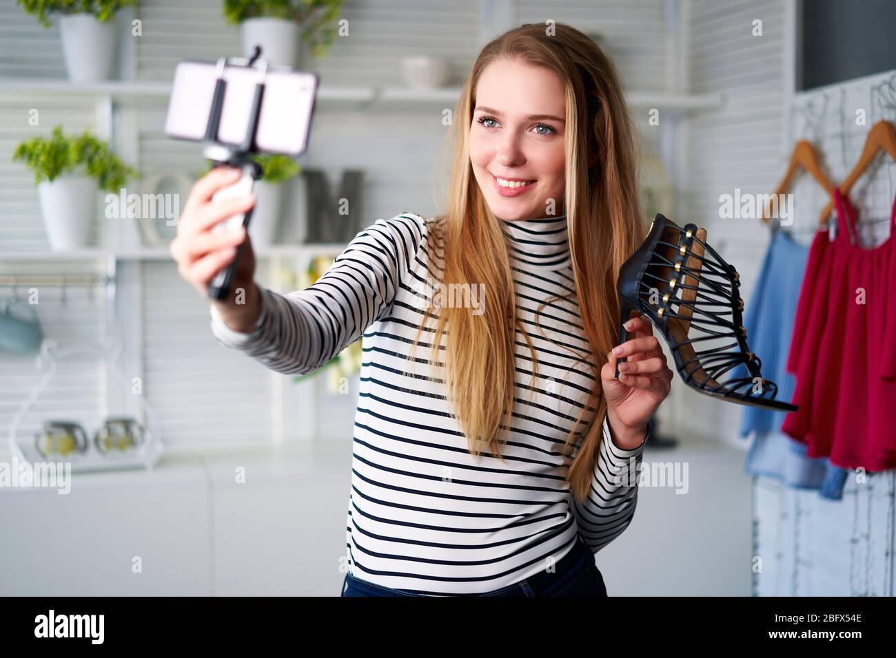 Fashion blogger woman in jeans and turtleneck showing high heel shoes ...
