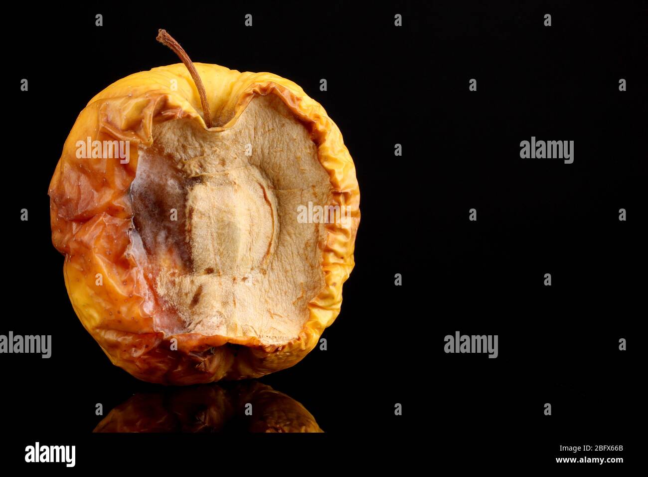 yellow moldy apple as concept of skin problems, isolated on black Stock ...