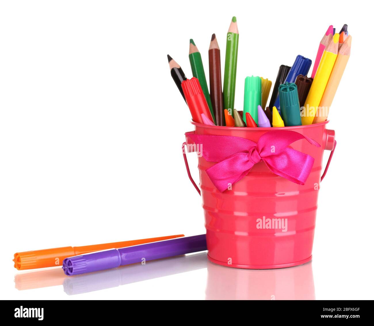 Colorful pencils and felt-tip pens in pink pail isolated on white Stock ...