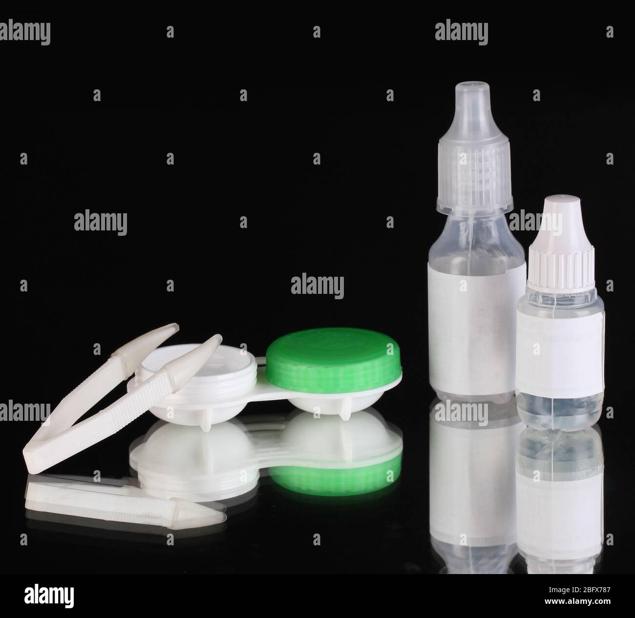 Eye drops and lenses on black background Stock Photo - Alamy