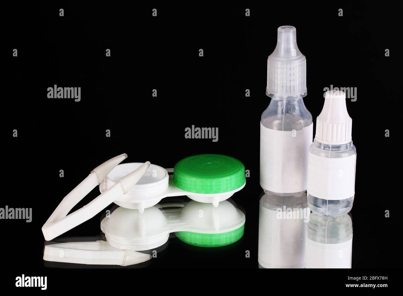 Eye drops and lenses on black background Stock Photo - Alamy
