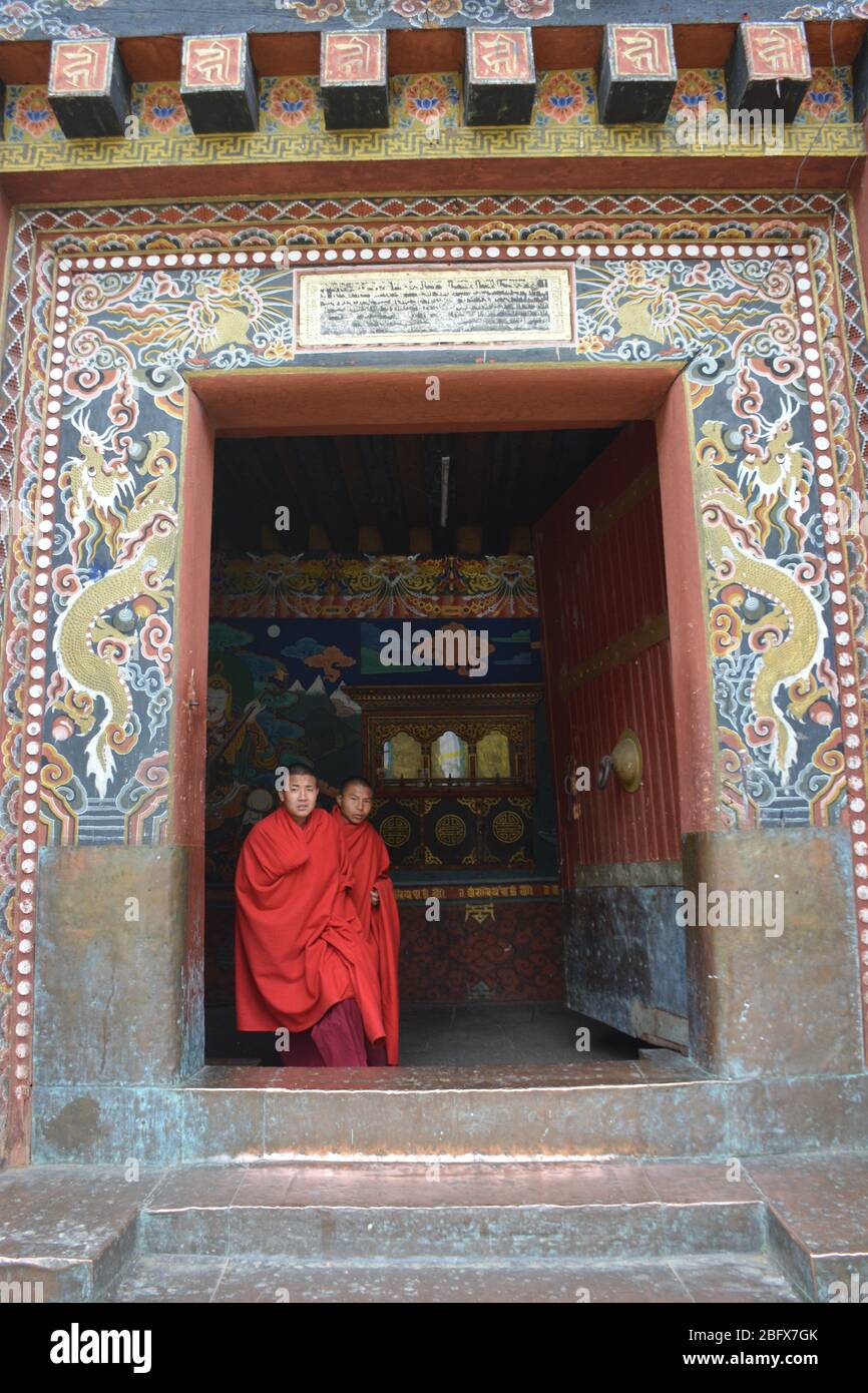 Two young monks in a doorway at Rinpung Dzong, the main monastery and ...