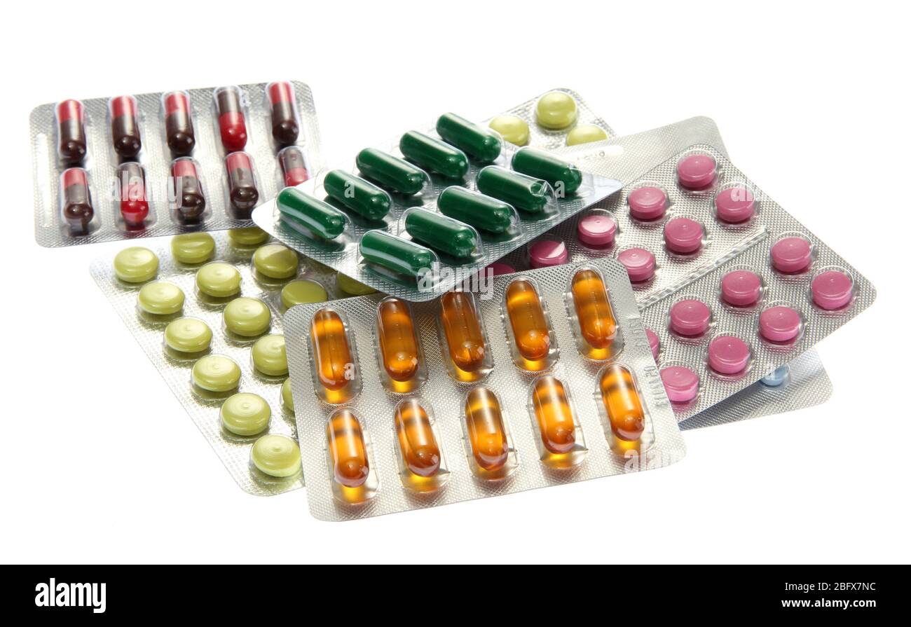 Capsules and pills packed in blisters, isolated on white Stock Photo ...