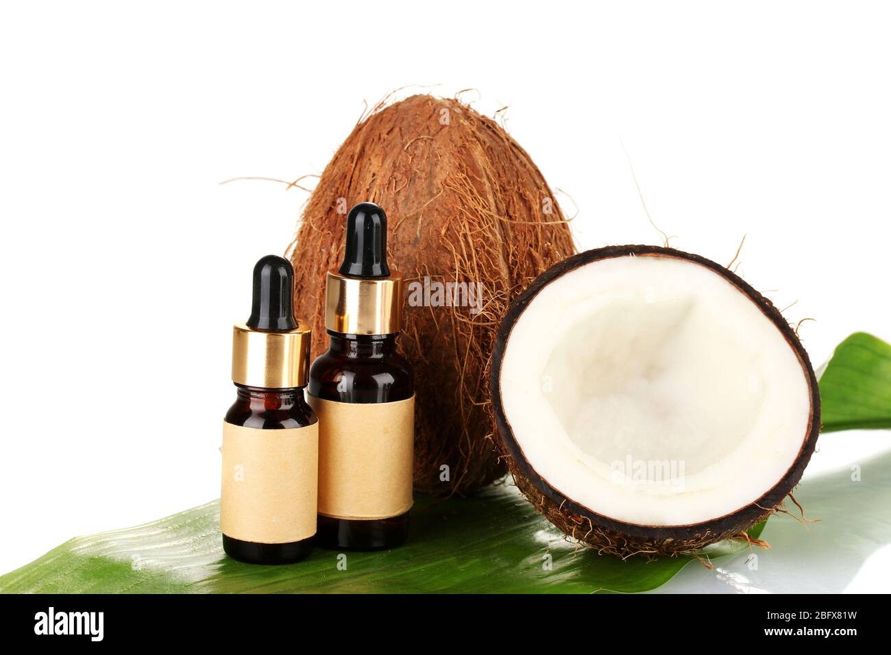 coconut oil in bottles with coconuts on white background Stock Photo ...